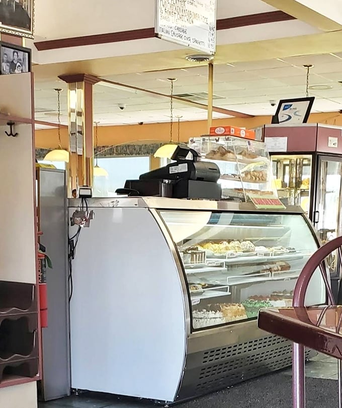 The dessert case—where willpower goes to die. Those pastries and cakes aren't just displayed; they're performing a siren song visible from every booth.