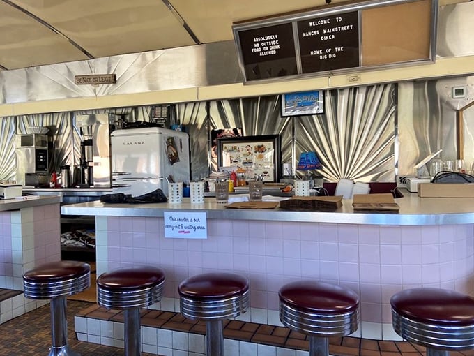The counter where magic happens – stainless steel, vinyl stools, and the promise of pie just behind that glass case.