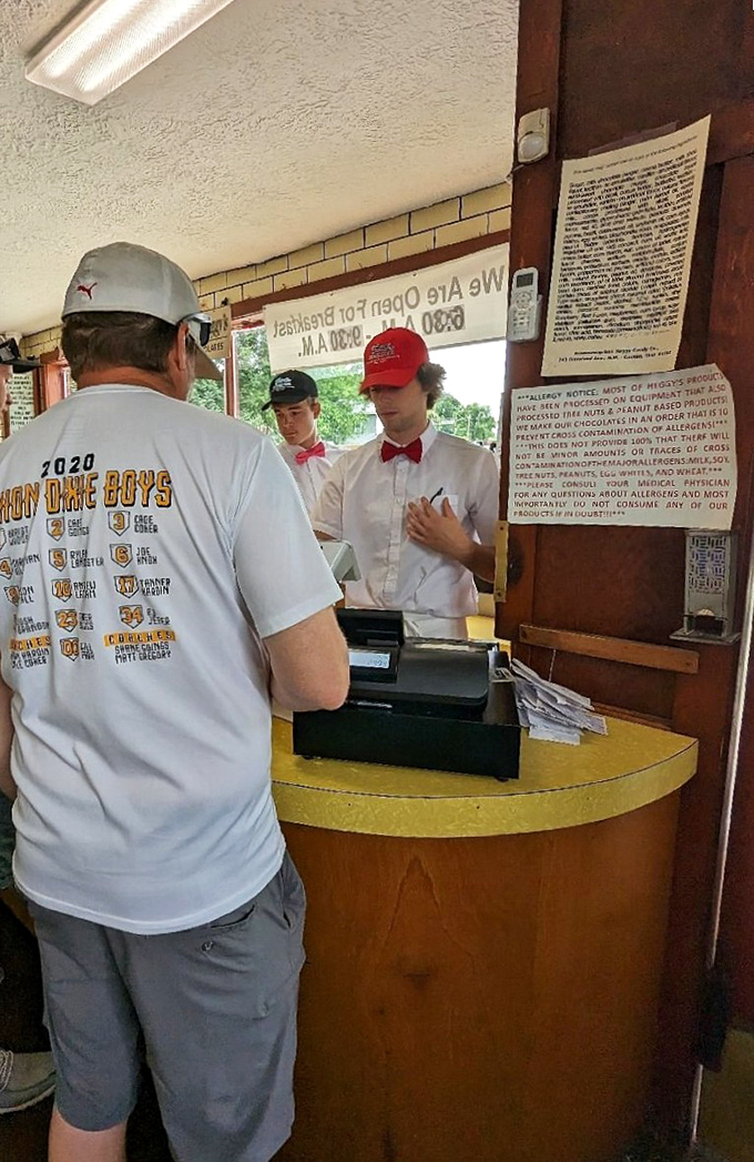 Young servers in bow ties and Tom's aprons—keepers of the ice cream flame, guardians of a sweet tradition that spans generations.