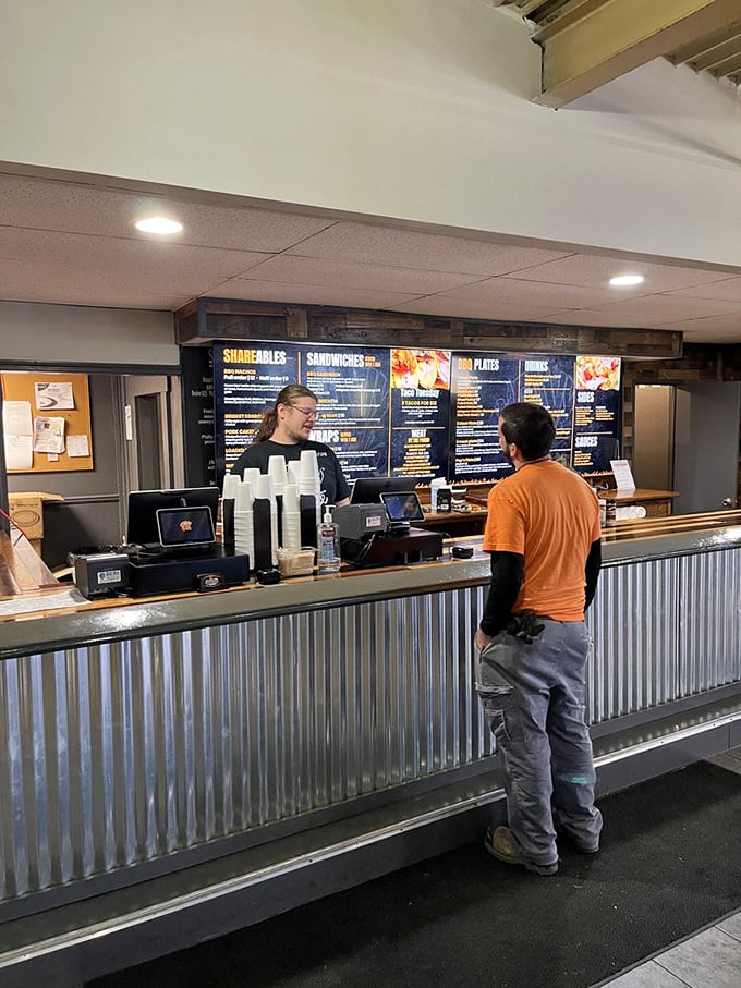 The ordering counter—that magical threshold where dreams of smoked meat become reality. Notice the corrugated metal? Classic barbecue joint aesthetic.