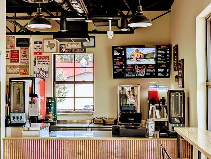 The ordering counter showcases vintage signs and modern efficiency in perfect barbecue restaurant harmony.