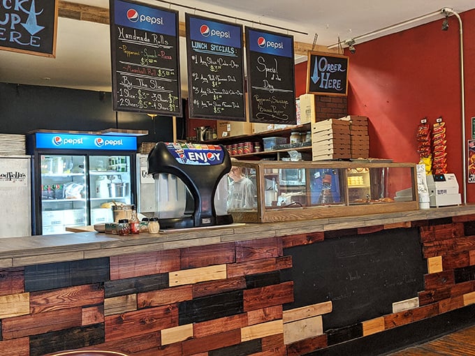 Behind this counter, pizza magic happens daily. The multi-colored wood panels add character to an already charismatic spot.