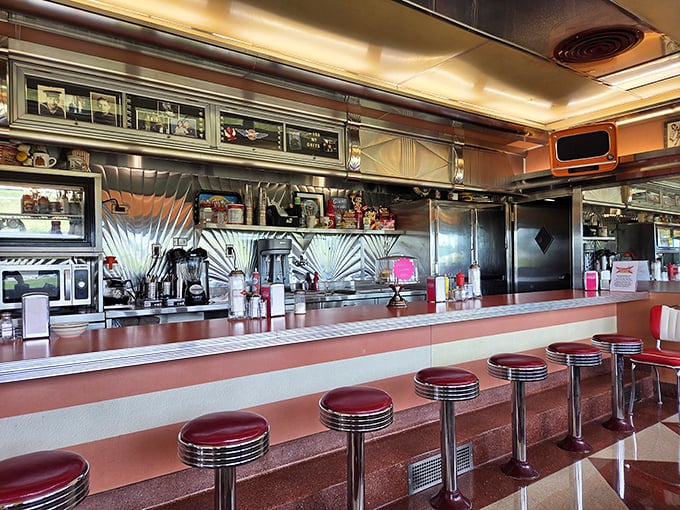 The counter where breakfast magic happens. Those red stools have witnessed countless first dates, family gatherings, and solo diners finding comfort in perfect hash browns.