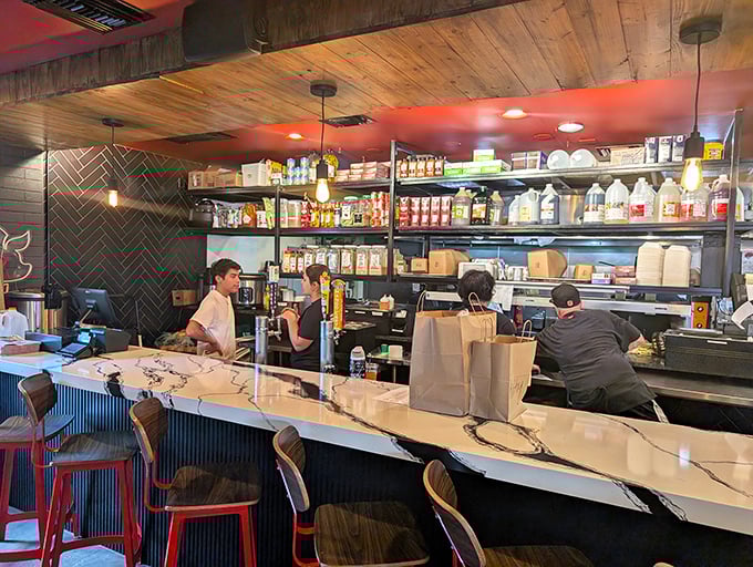 The counter offers front-row seats to culinary magic. Those shelves aren't just storage—they're a library of flavor possibilities.