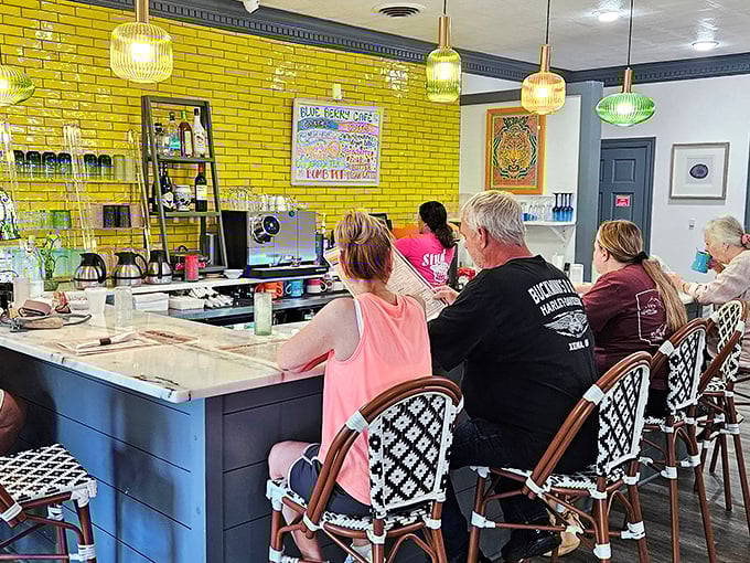 The counter seats – where breakfast aficionados watch the magic happen. That vibrant yellow brick wall adds sunshine even on cloudy mornings.