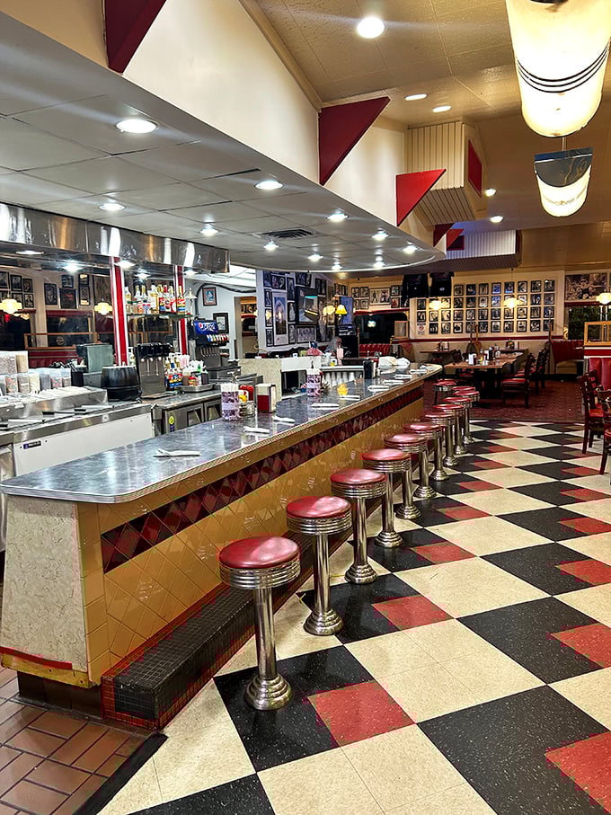 The counter where solo diners find community, watching short-order ballet while perched on chrome-stemmed stools that have witnessed countless coffee refills.