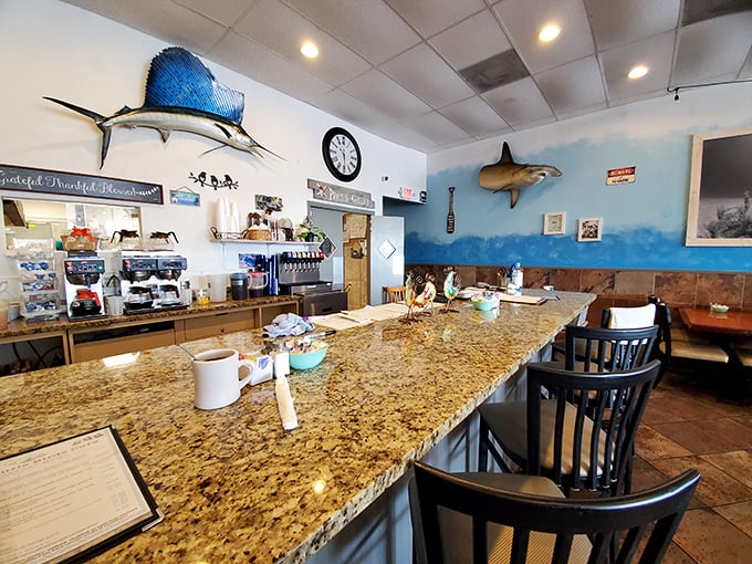 Counter seating with a view of the action—where fishing trophies watch over your breakfast like aquatic guardians.