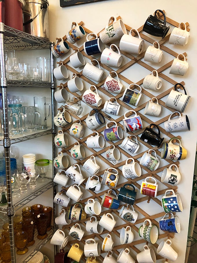A wall of mugs displaying more personality than most people's entire kitchen cabinets – choose your morning companion wisely.