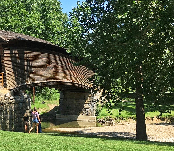 Beneath the bridge, adventures await. The massive stone foundations have supported countless crossings while offering visitors a cool place to explore.