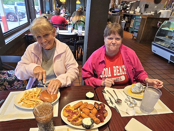 These ladies aren't just having lunch—they're holding a summit conference where world problems are solved between bites of perfectly golden fried goodness.