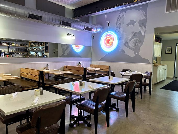 The dining area's industrial-chic vibe gets softened by wooden tables and ambient lighting. That wall mural adds just the right touch of character.