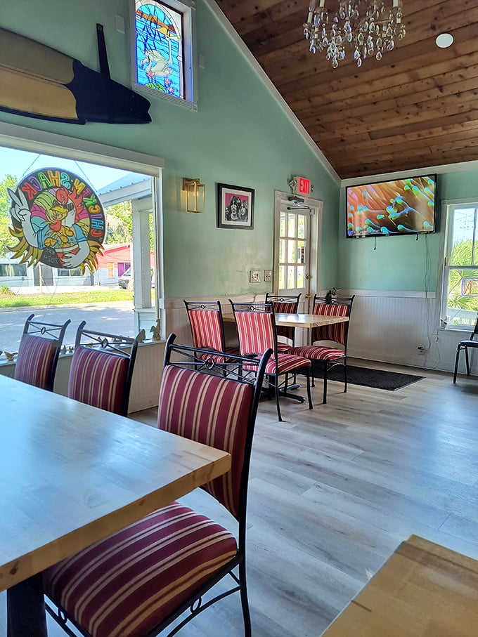 The interior feels like a beach cottage that decided to feed the neighborhood—complete with stained glass, a chandelier, and coastal charm to spare.