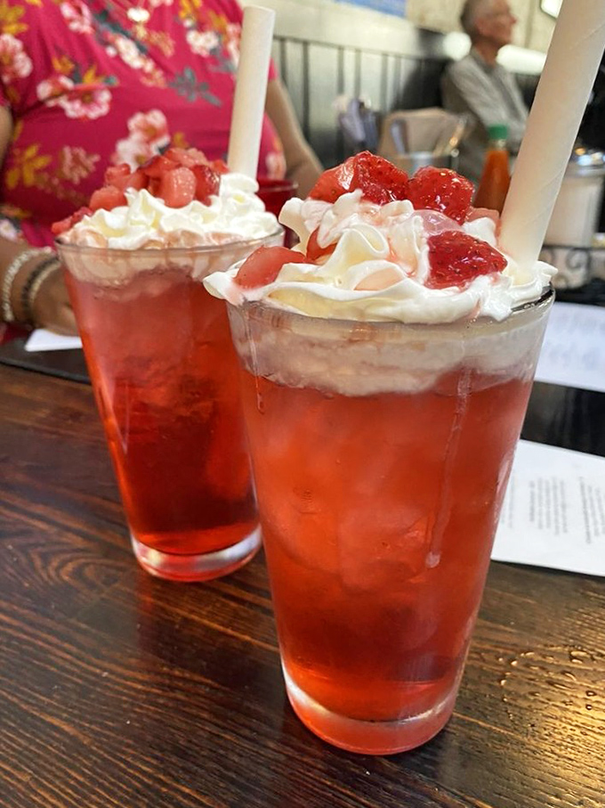 These strawberry-topped drinks aren't just refreshing – they're like summer vacation in a glass, complete with whipped cream vacation homes.
