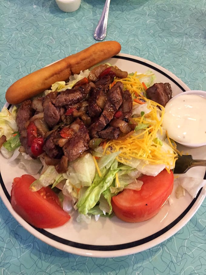 A steak fajita salad that lets you pretend you're eating healthy while enjoying every savory, protein-packed bite. The breadstick is non-negotiable.