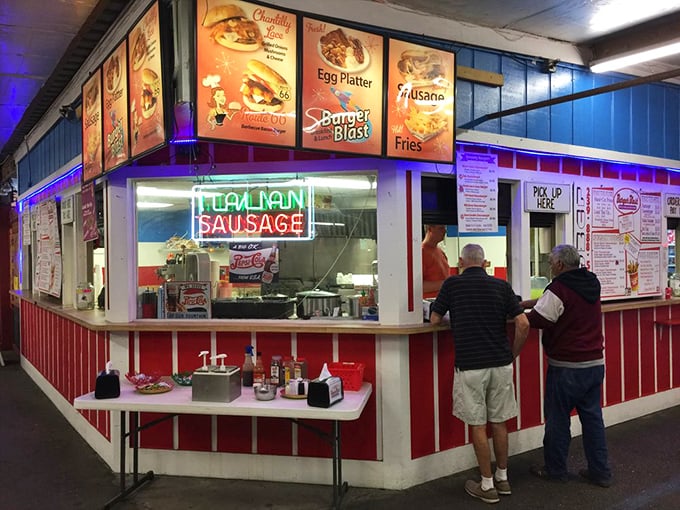 The neon "ITALIAN SAUSAGE" sign beckons hungry shoppers. Market fuel that makes bargain hunting possible for another three hours!