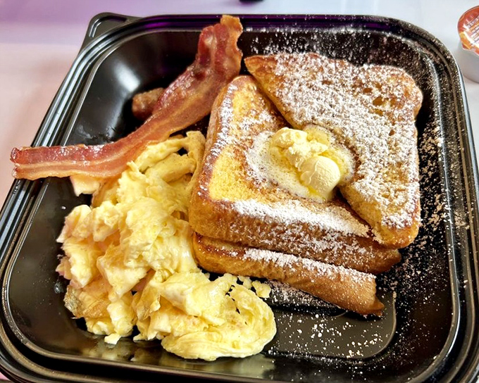 French toast that's dressed for success with a dusting of powdered sugar and a crown of butter. Those eggs and sausage are the perfect supporting cast.