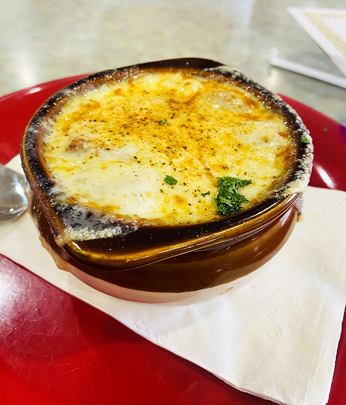 This French onion soup isn't messing around. That cheese cap is holding on tighter than my pants after Thanksgiving dinner.