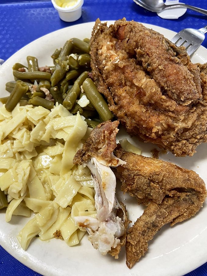 This isn't just fried chicken—it's edible nostalgia served with green beans and noodles that deserve their own fan club.