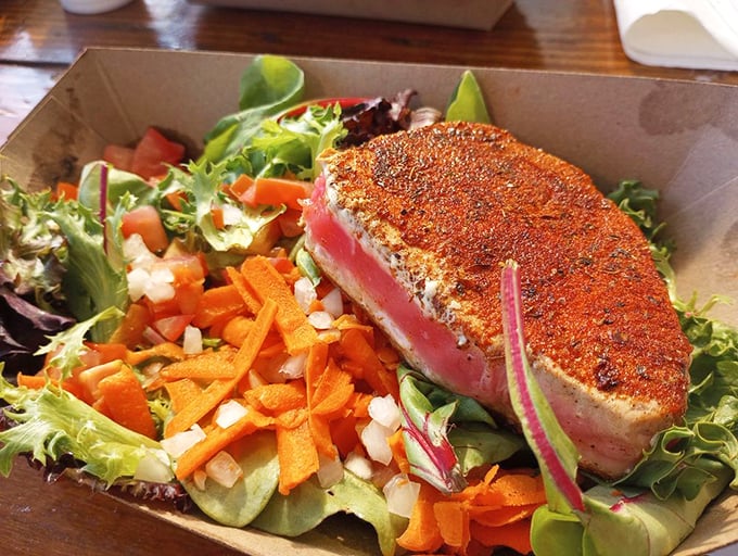 Seared ahi tuna perched atop fresh greens – proof that not everything delicious at Neptune's Net requires a deep fryer.