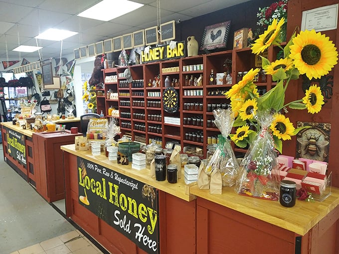 The Honey Bar buzzes with sweet possibilities—rows of golden jars catching the light while sunflowers stand guard over nature's perfect sweetener.