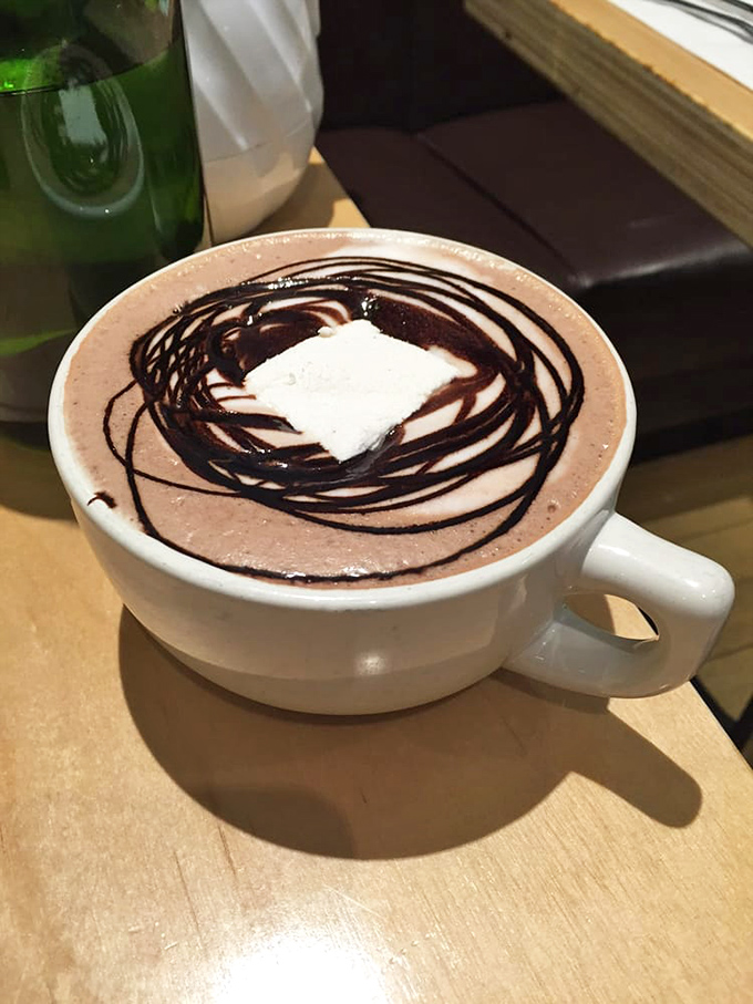 Hot chocolate that doesn't just warm your hands—it hugs your soul. Those chocolate drizzles aren't decoration; they're a promise.