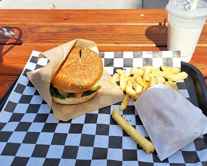 The burger and fries combo on its checkered throne proves that sometimes the simplest pleasures deliver the most profound satisfaction.