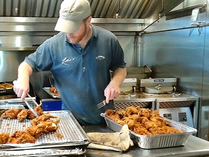 The maestro at work, transforming simple chicken into the golden, crispy masterpieces that have locals lining up and out-of-towners planning detours through Hockessin.