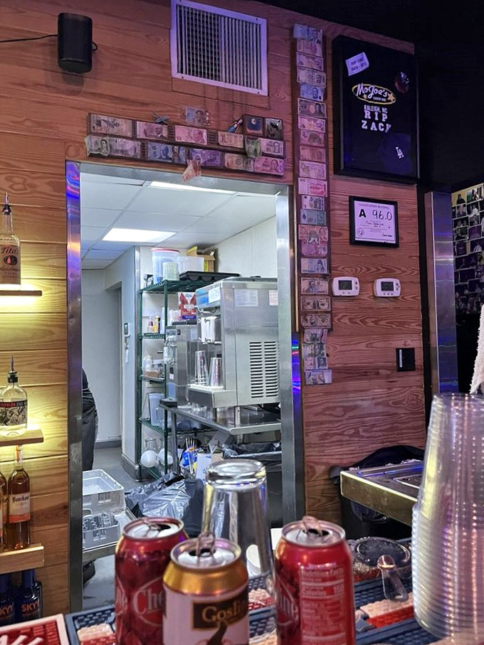 A glimpse into the kitchen—the engine room where burger magic happens. Those dollar bills on the wall? Each one represents a satisfied customer's gratitude.