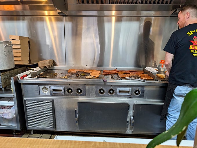 The flat-top grill—hallowed ground where hot dog magic happens. Some might call it cooking; I call it performance art.