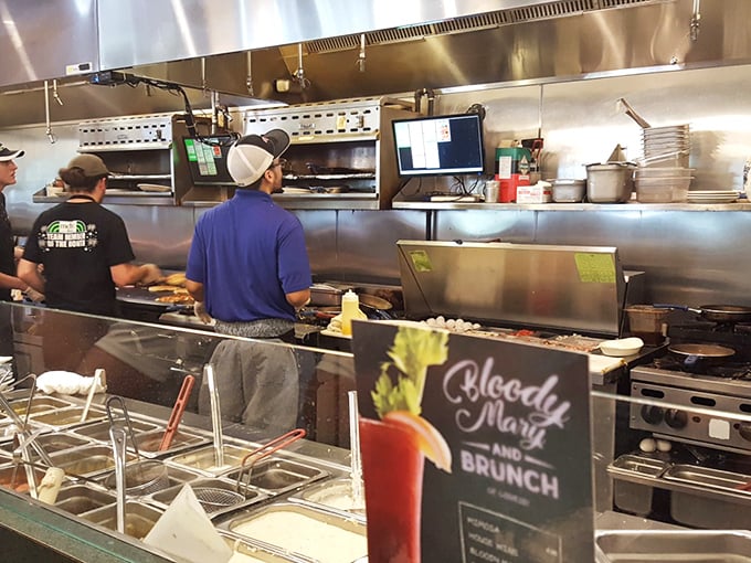 The open kitchen—where breakfast dreams come true and Bloody Marys are born. These culinary wizards don't need curtains to hide their magic.