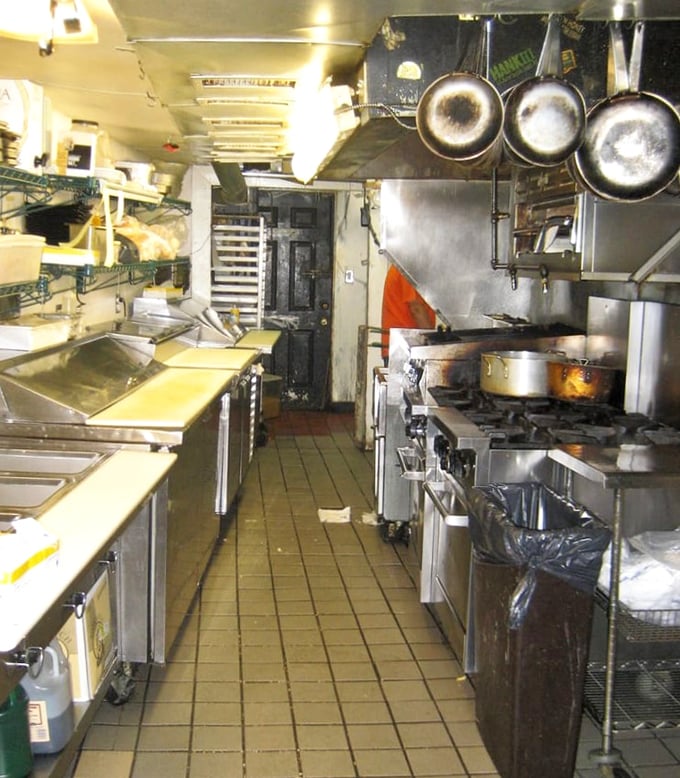 The kitchen where the magic happens. Small space, big flavors—like a culinary TARDIS that's bigger on the inside.