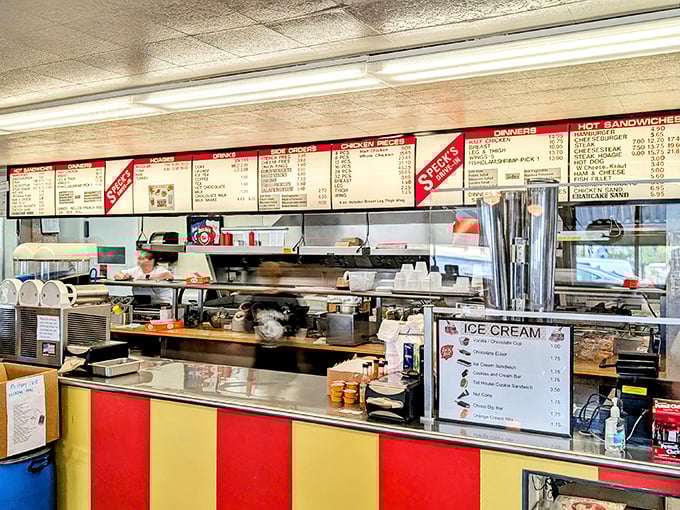 Behind the counter, where the magic happens. That menu board has probably witnessed more food dreams come true than a cooking show marathon.