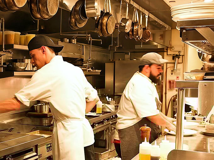 The kitchen ballet—where the magic happens. Pots hanging overhead like delicious possibilities waiting to drop onto your plate.