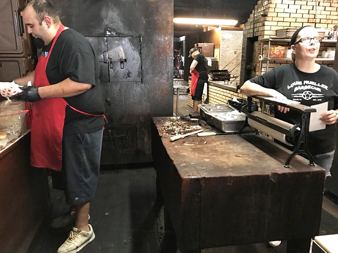 The kitchen – where smoke and time transform ordinary meat into extraordinary memories. Those cutting boards have stories to tell.