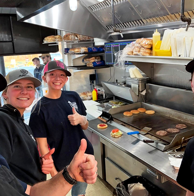 The grill where ordinary ingredients transform into extraordinary memories—these smiling faces are the unsung heroes of summer happiness.