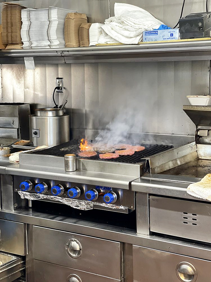 Where the magic happens – flames kiss patties into submission while skilled hands orchestrate the burger symphony.