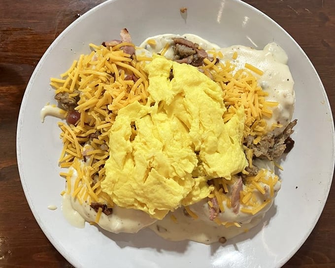This isn't just breakfast—it's breakfast with ambition. Eggs, cheese, and sausage gravy creating a morning masterpiece that laughs in the face of hunger.