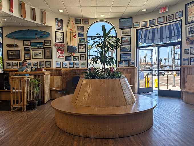 The central plant island isn't just decor—it's a tropical oasis surrounded by surf memorabilia and hungry breakfast enthusiasts plotting their day.