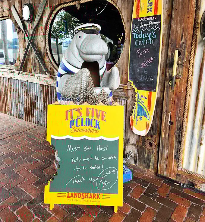 Even the manatee statue knows it's five o'clock somewhere—a whimsical reminder that vacation rules apply at The Lazy Flamingo.