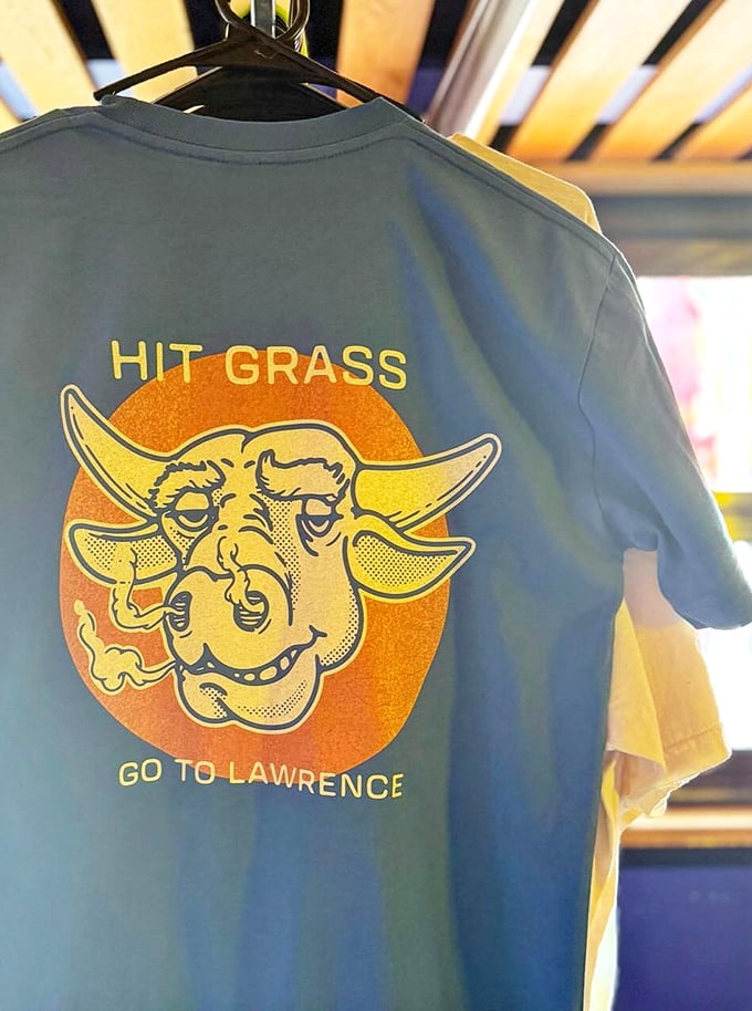 Not just merch—it's wearable BBQ philosophy. "Hit Grass, Go to Lawrence" might be the best advice you'll get all year. 