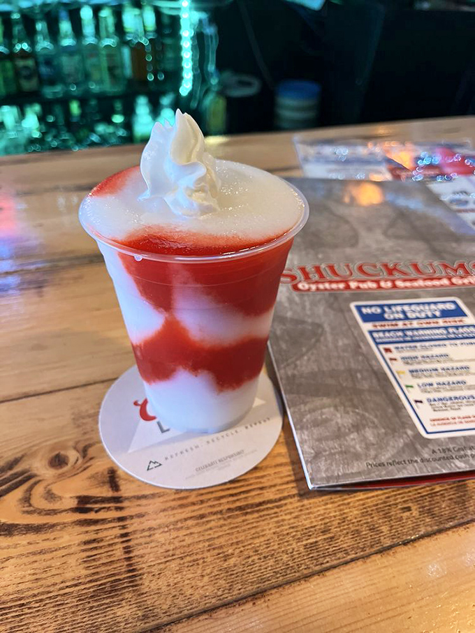 A Miami Vice that looks like a sunset in a glass. The whipped cream on top isn't just garnish—it's the cloud floating above your personal paradise.