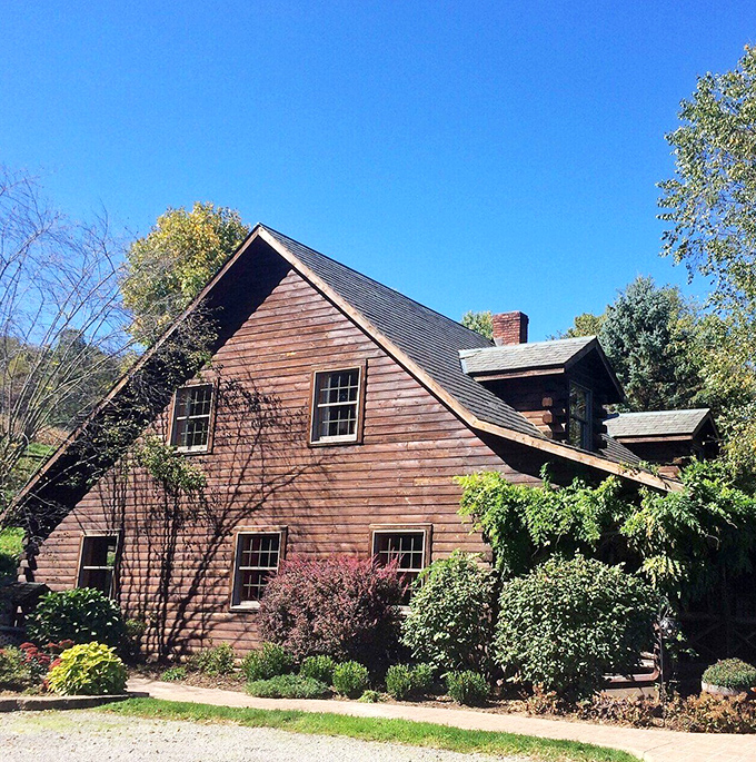 This isn't a movie set—it's someone's actual home. The weathered wood and meticulous landscaping speak to generations of care and stewardship.