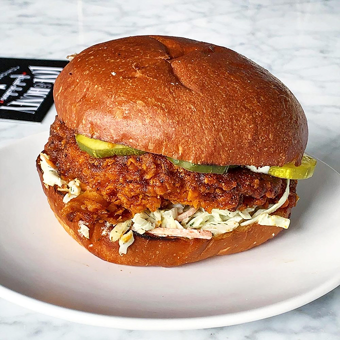 The Nashville Hot Chicken Sandwich—where pleasure and pain find perfect harmony. Those pickle chips aren't just garnish; they're survival equipment.