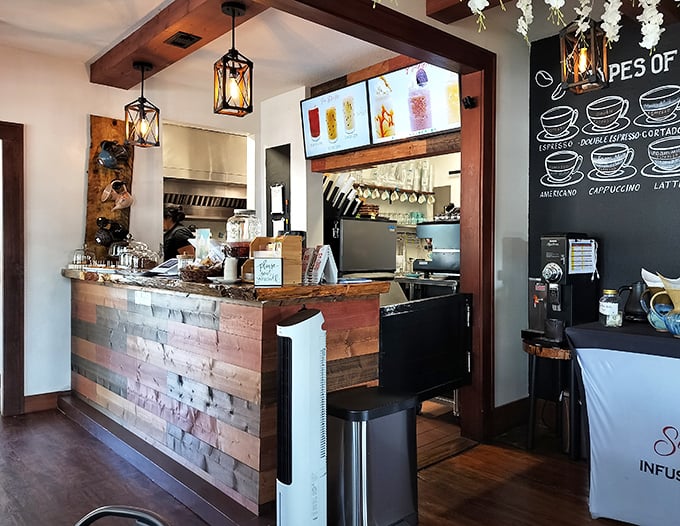 The reclaimed wood counter serves as command central for caffeine operations, with a chalkboard menu of coffee options that reads like poetry to the sleep-deprived.