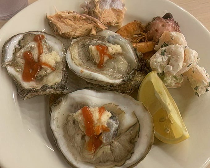 These oysters, dressed with just a touch of sauce and paired with a lemon wedge, are the ocean's perfect little appetizers.