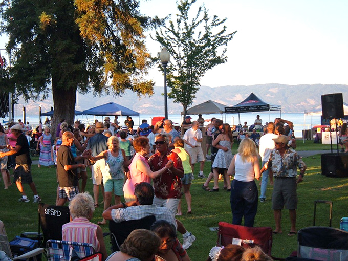 Summer concerts in the park—where strangers become dance partners and the lake provides the perfect backdrop for music that floats across generations.