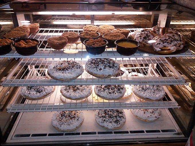 The dessert case—where willpower goes to die and "I'll just have a bite" becomes the lie you tell yourself before ordering a whole pie.