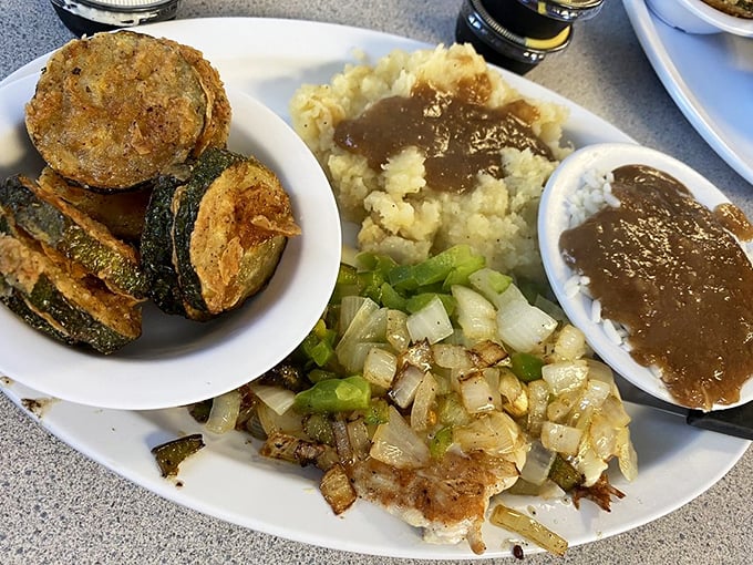 Fried zucchini, mashed potatoes with gravy, and sautéed onions—a plate that proves vegetables can be just as comforting as dessert.