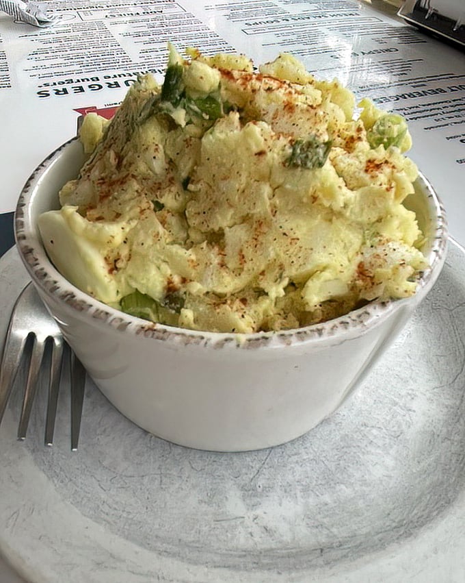 Potato salad that your grandmother would approve of—maybe even secretly envy. That paprika sprinkle isn't just color—it's a flavor flare.