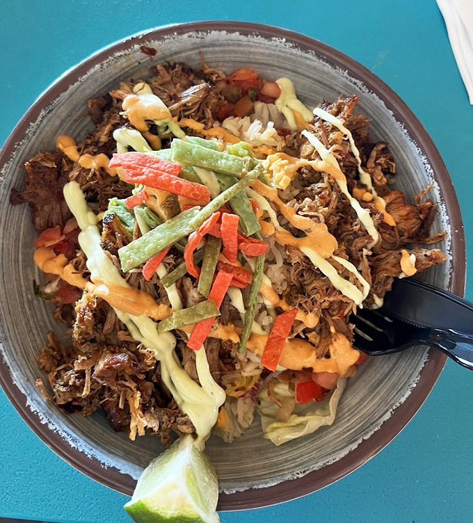 The pulled pork bowl transforms humble ingredients into something magnificent—like if your grandmother's comfort food went to culinary school in the Caribbean.